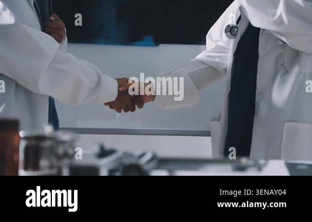 doctor and medical staff shaking hands, standing together in hospital ...