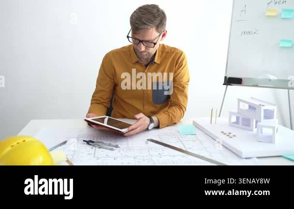 Architect or engineer meticulously drawing and analyzing detailed ...