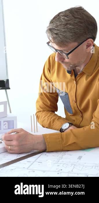 Professional male architect or civil engineer working at a desk ...
