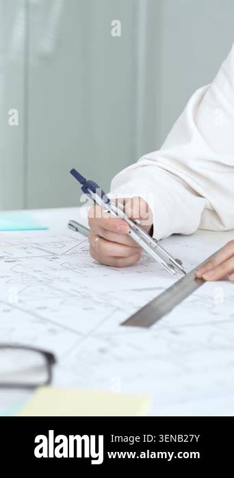 Professional woman drafting architectural blueprints using drawing ...