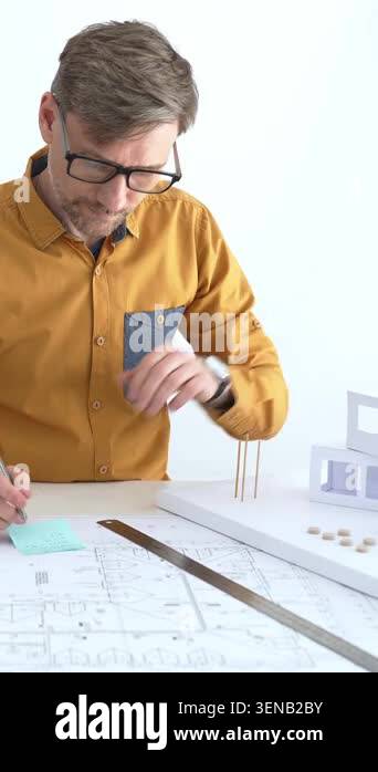 Professional male architect or civil engineer working at a desk ...