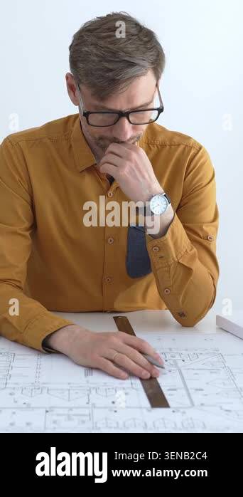 Professional male architect or civil engineer working at a desk ...