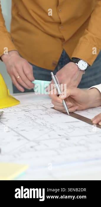 Professional architect concentrating on architectural blueprints and a ...