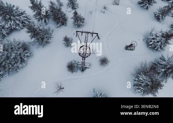 Top down aerial view of ski lift machinery and support structures ...