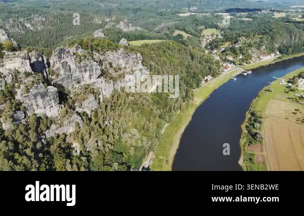 Wide aerial panorama of sandstone rock formations, dense forest, cliff ...