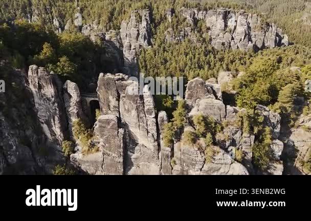 Close aerial view of clustered sandstone cliff columns, rugged rock ...