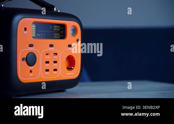 Portable charging power station standing on table indoors, slow motion ...