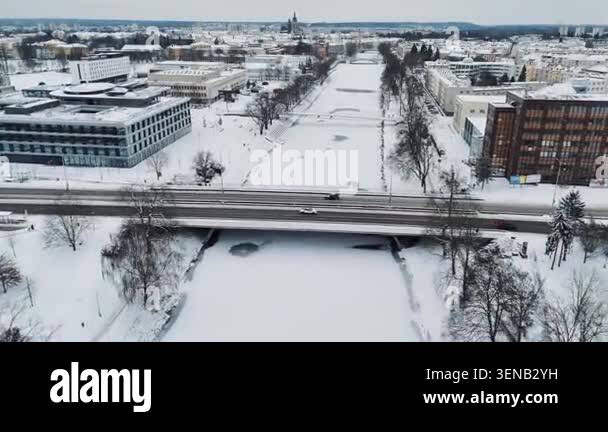 An aerial drone shot shows a snow-covered urban landscape in Hradec ...
