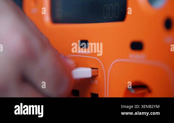 Person plugging USB cable into portable power station. Charging ...