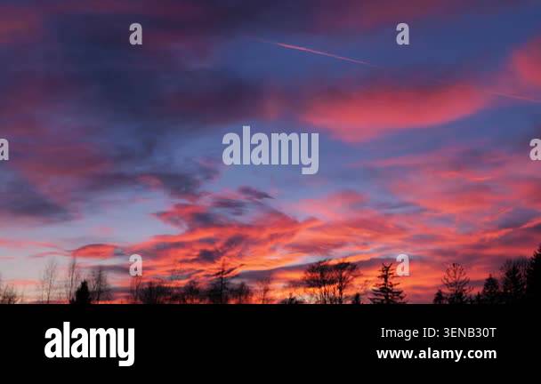 A wide shot of colorful pink, orange, and purple clouds during a sunset ...