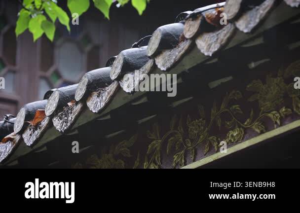 Close-up of raindrops sliding down the roof tiles of an ancient ...