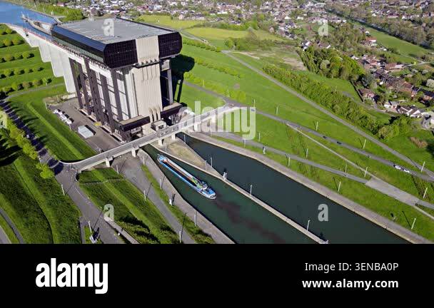 Static aerial drone view of cargo barge approaching and entering canal ...