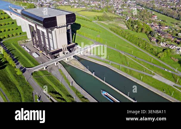 Aerial drone overhead shot of cargo barge passing through canal near ...