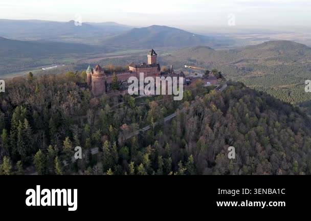 Aerial view of medieval castle perched above vineyard terraces and ...