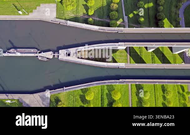 Aerial drone view of vessel navigating narrow canal near boat lift with ...