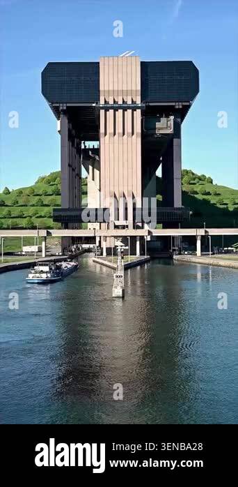 Static view of vessel moving through narrow channel beneath massive ...