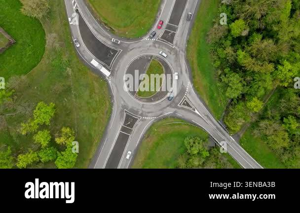Aerial orbital drone top-down view of roundabout intersection with ...