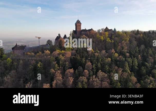 Aerial view of medieval castle tower silhouette rising through morning ...