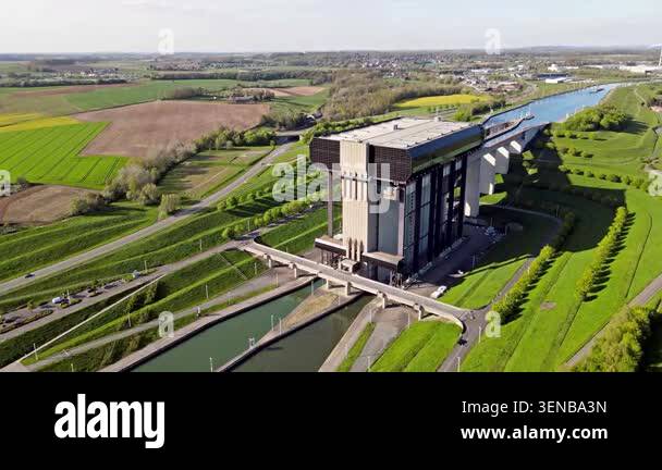 Aerial drone perspective of cargo barge on rural canal flanked by ...