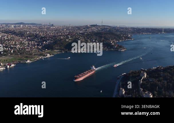 Aerial view of a large bulk carrier cargo ship navigating the bosphorus ...