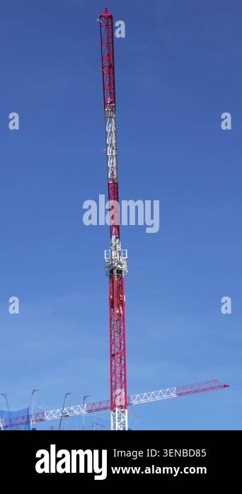 Vertical static shot of a tower crane mast isolated against a clear ...