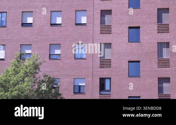 Modern red brick residential apartment building facade with repetitive ...