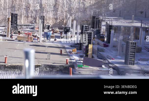 Active construction site with concrete columns, formwork systems, heavy ...