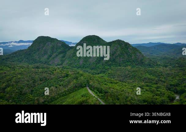 Aerial Drone View of Twin Karst Peaks Rising Above Tropical Rainforest ...