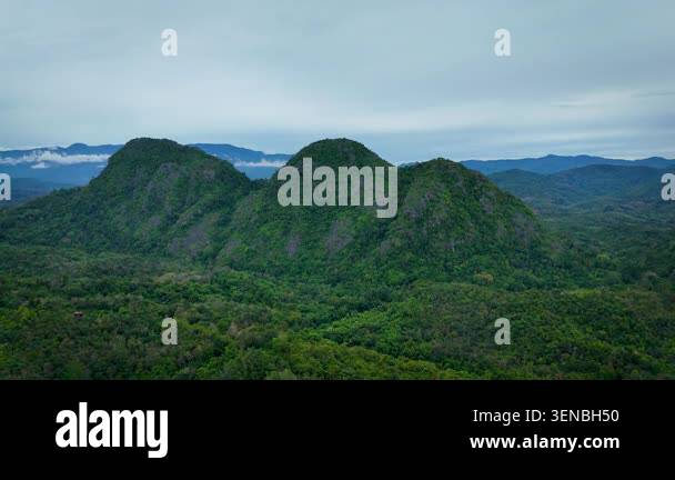 Aerial Drone View of Twin Karst Peaks Rising Above Tropical Rainforest ...