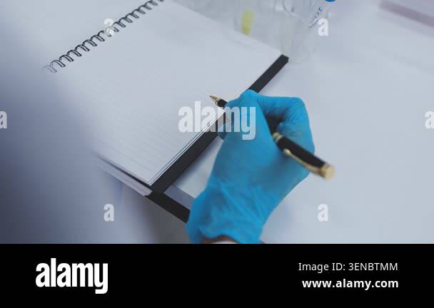 doctor hand writing on clipboard in laboratory Stock Video Footage - Alamy