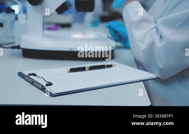 close - up of scientist holding a microscope in laboratory. research ...