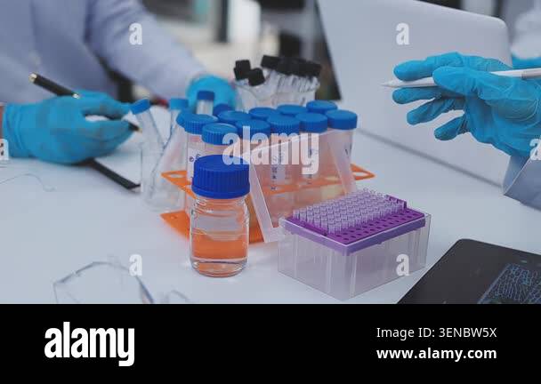 laboratory assistant in protective gloves and protective gloves holding ...
