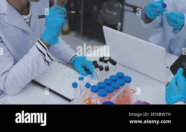 close up of a scientist holding a test tube and a sample Stock Video ...