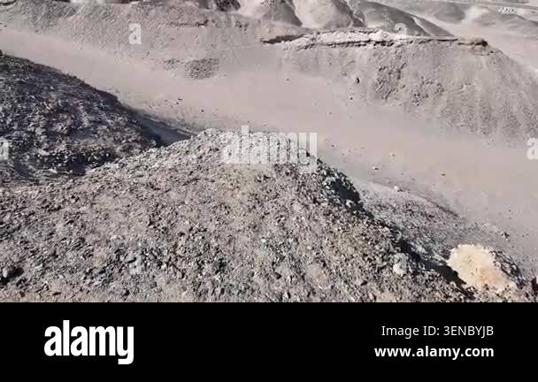 Vast, arid desert landscape slowly revealed by a tilting camera ...