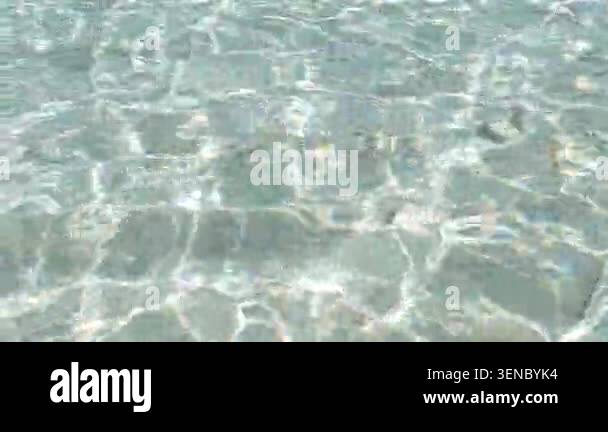 Tranquil surface of crystal-clear turquoise water rippling under the ...
