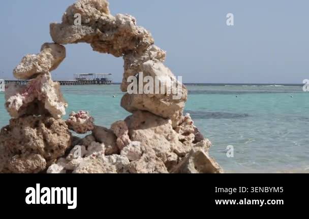 Beautiful rock arch sculpture made of stones and coral balancing on a ...