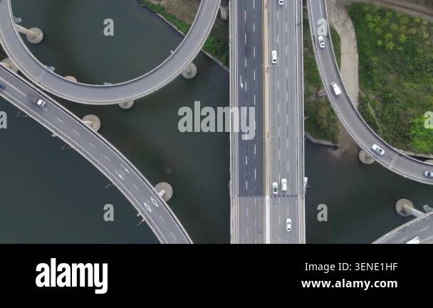 Road junction and bridge on river in the city, top view Stock Video ...