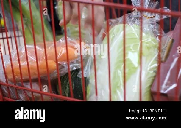 Red grocery cart with vegetables and fruits close-up for the front ...