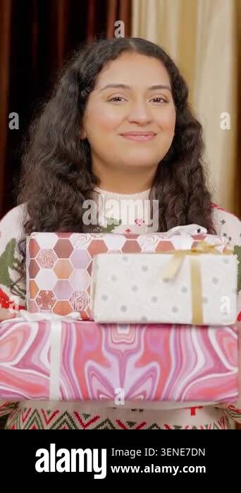Vertical Video of Indian Woman Holding Christmas Gifts with Christmas ...