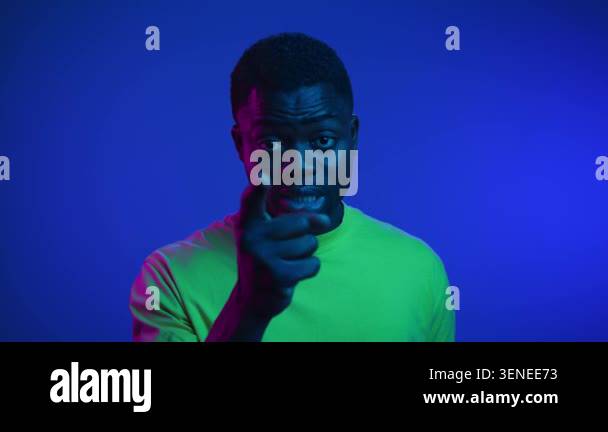Portrait of Black Man Looking at Camera with Pointing Finger Gesture ...