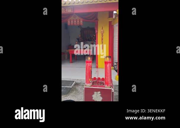 A vertical shot of a traditional Chinese temple altar with red lanterns ...