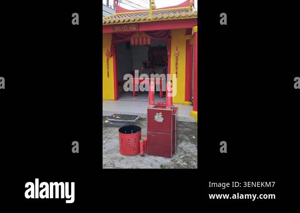 A vertical shot showing a traditional Chinese temple altar with red ...