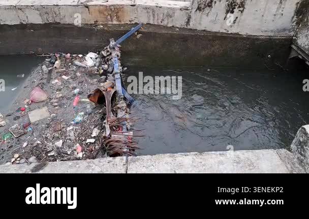 A horizontal video capturing an urban public drainage canal filled with ...