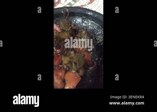 A vertical close-up shot of dark red Indonesian shrimp paste chili ...