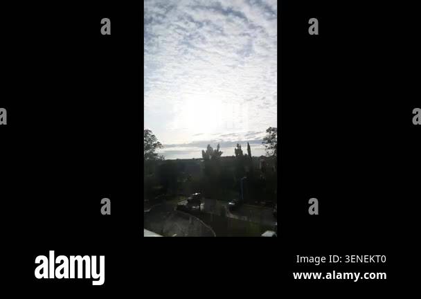 A wide vertical shot of a dramatic sky with wispy clouds over a ...