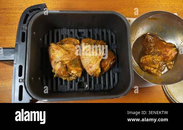 Raw pre-pickled chicken thighs in bowl and air grill Stock Video ...