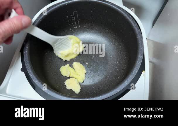 Melting of solid animal fat in household multi-cooker pot Stock Video ...