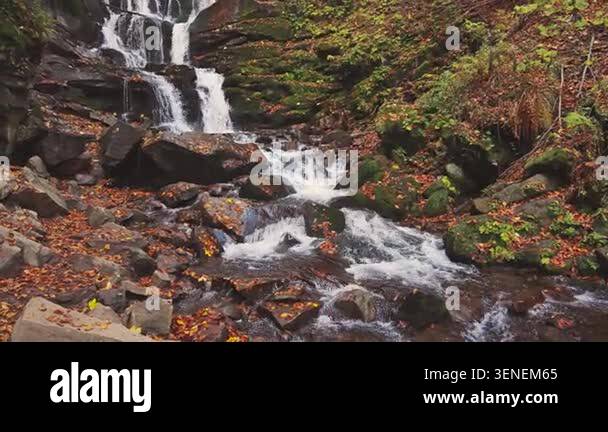 Slow-motion 4K pan video waterfall stream falling down rocks and stones ...