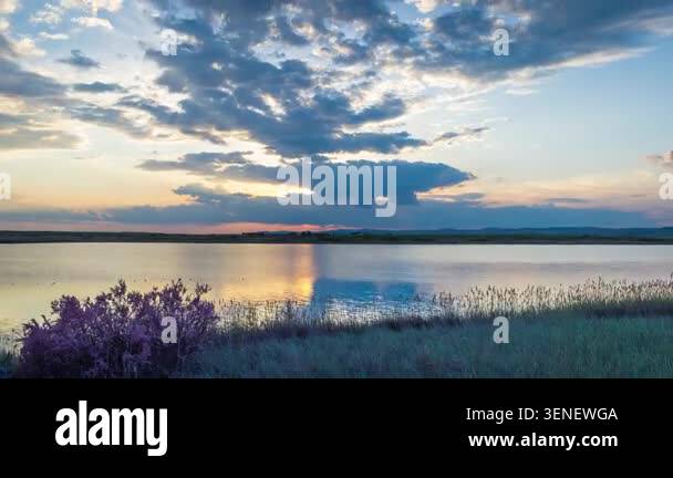 Large thick powerful clouds run across the blue evening sky with a ...