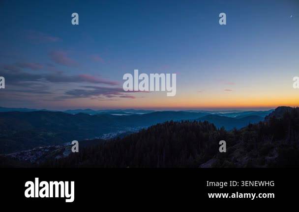 Cloudy weather over low hills covered with spruce evergreen forests in ...